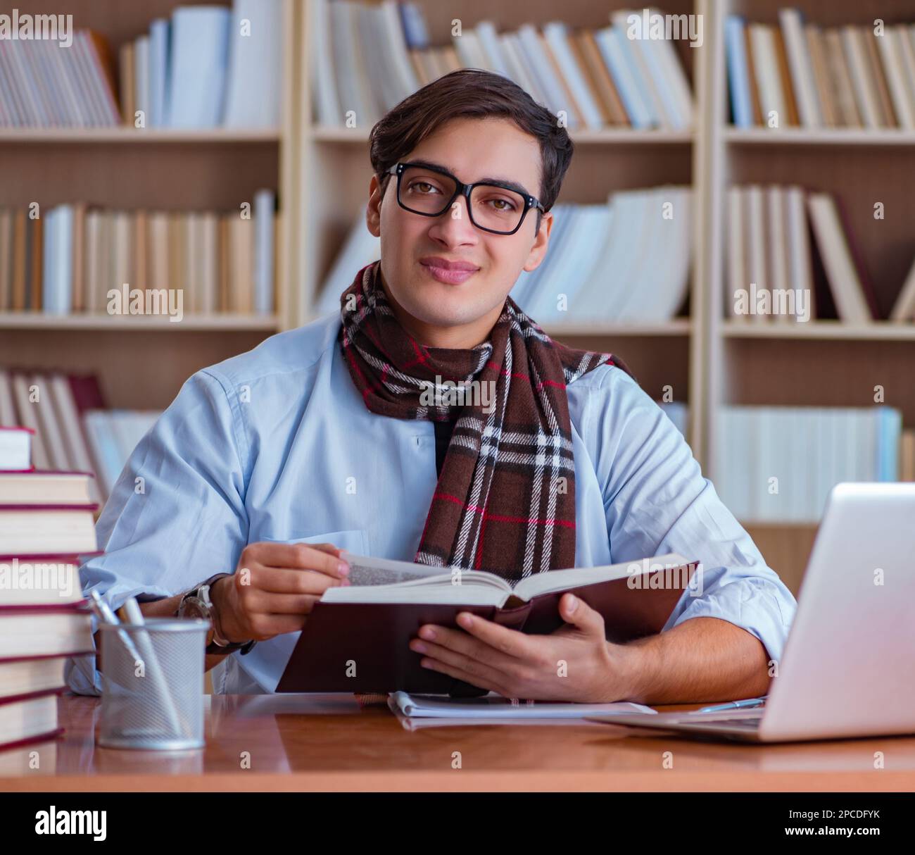 The young book writer writing in library Stock Photo - Alamy
