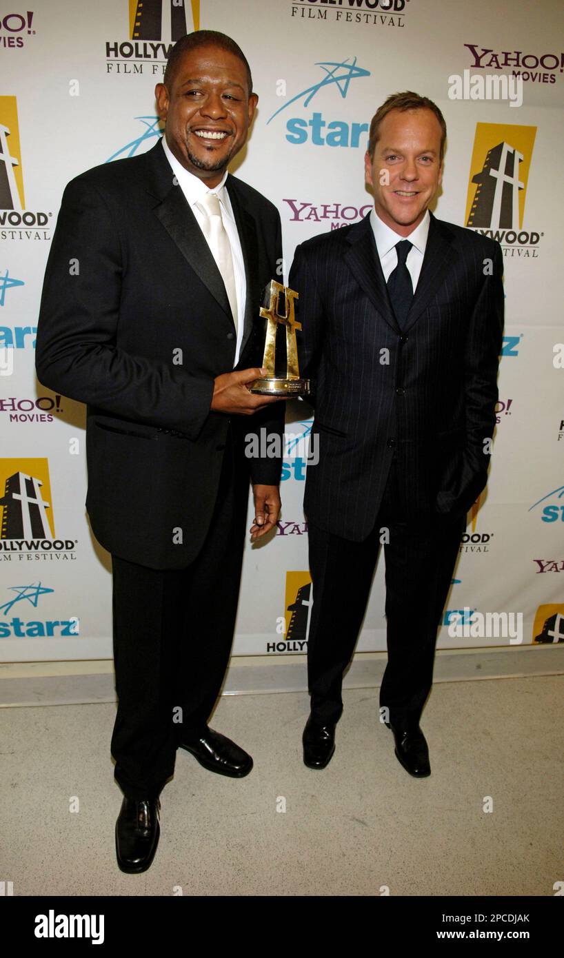 Forest Whitaker holds his actor of the year award backstage with Kiefer ...