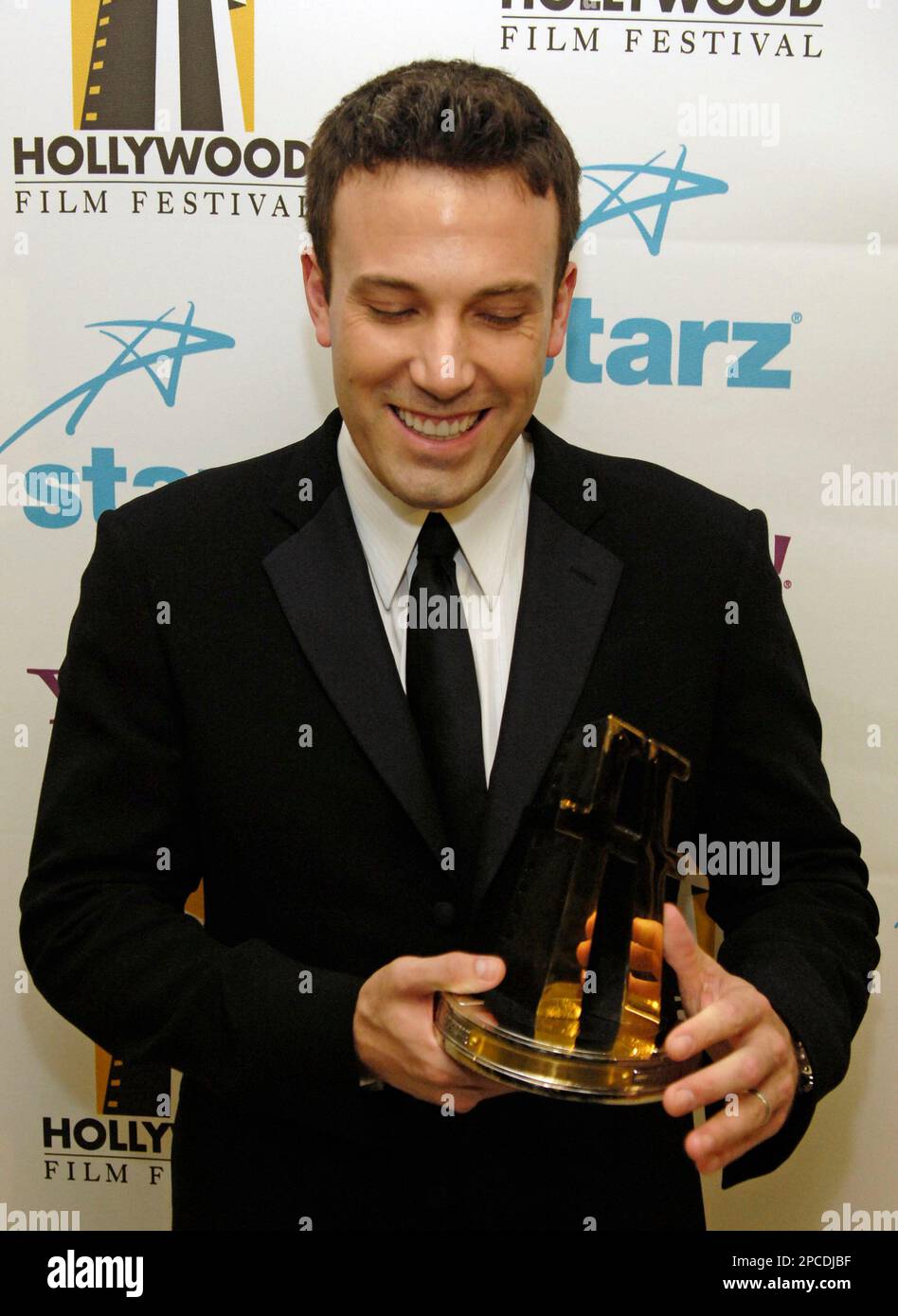 Ben Affleck holds the supporting actor award backstage during the 10th ...