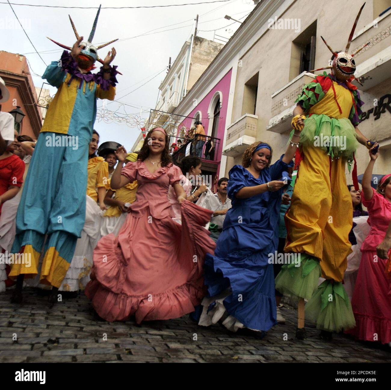 Traditional carnival revelers called "Vegigantes" join the crowd during ...