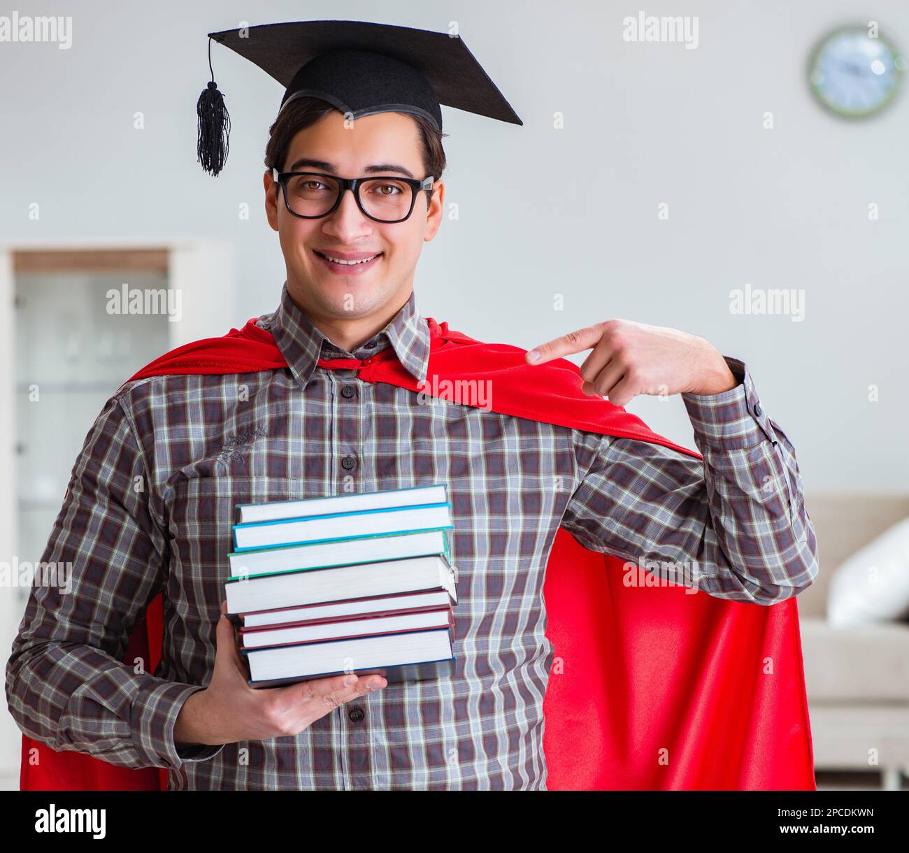 The super hero student with books studying for exams Stock Photo - Alamy