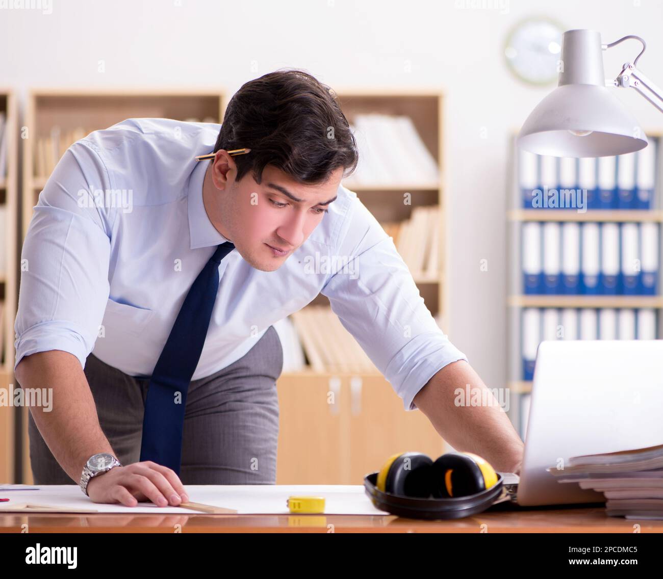 The engineer supervisor working on drawings in the office Stock Photo ...