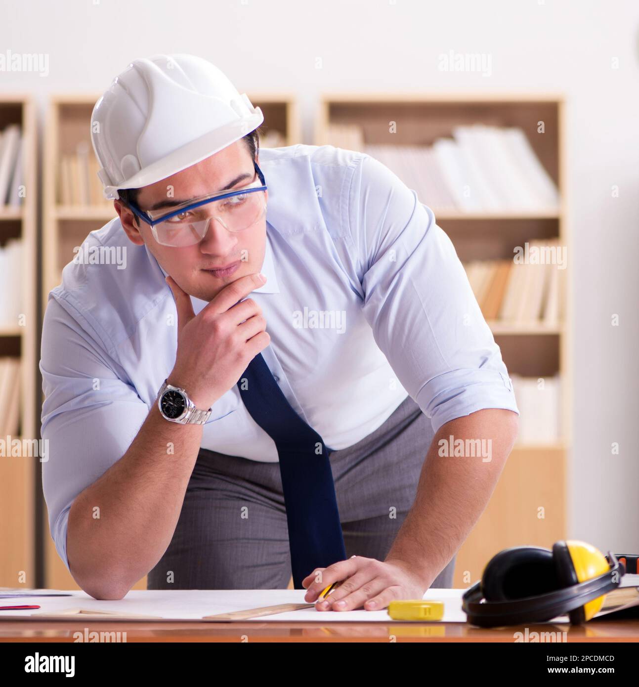 The engineer supervisor working on drawings in the office Stock Photo ...