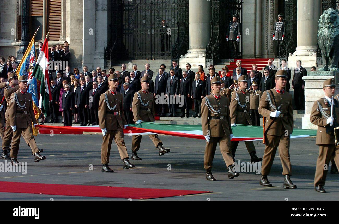 Members of Hungarian guards of honour carry the Hungarian national flag ...
