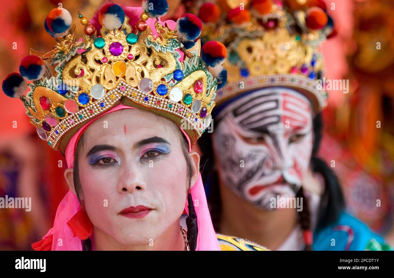 Worshippers dressed as a generals of the Chinese mythology wait in the ...