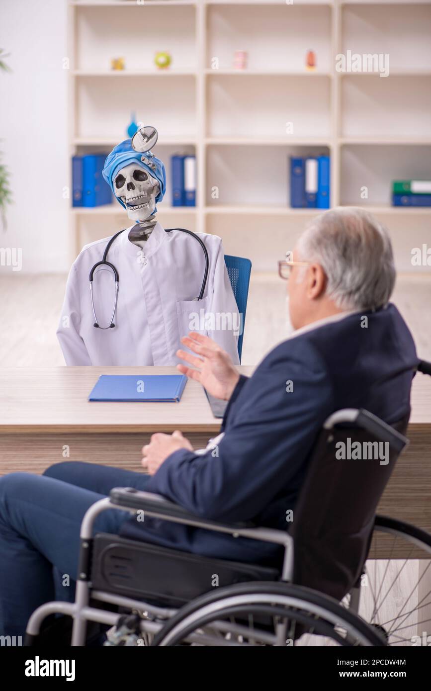 Old male patient in wheel-chair visiting devil doctor Stock Photo - Alamy