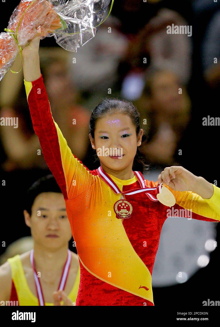 Gold medalist China's Cheng Fei holds up her medal as she stands on the ...