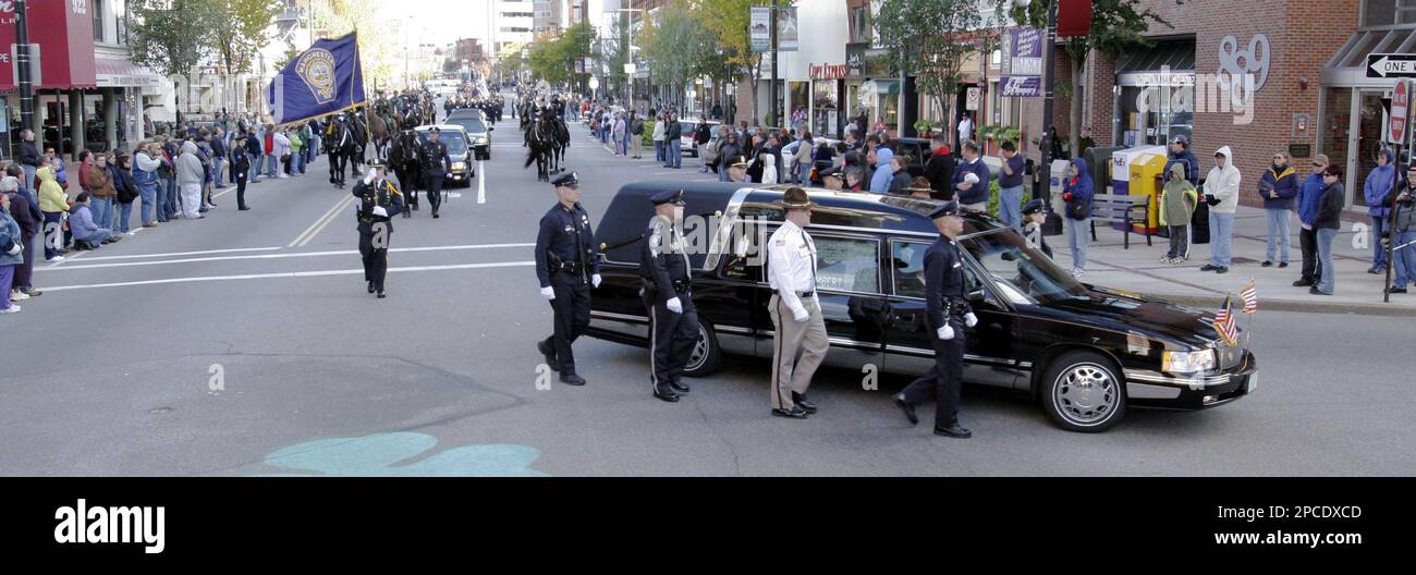 A hearse carries the body of police officer Michael Briggs on Elm ...
