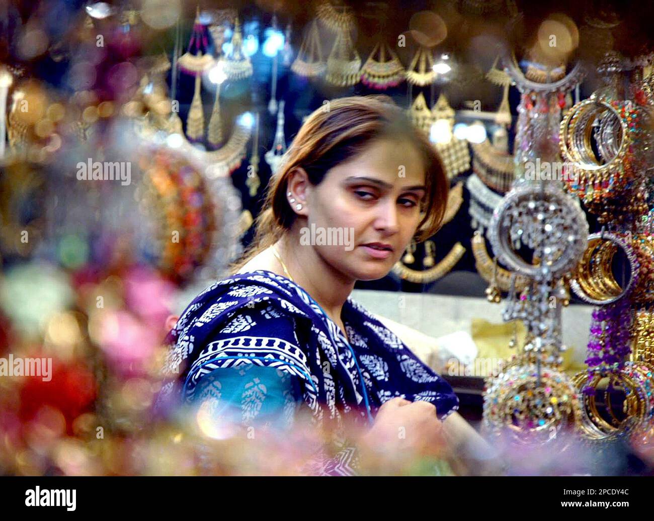 A Pakistani woman chooses jewellery ahead of the Muslim festival of Eid ...