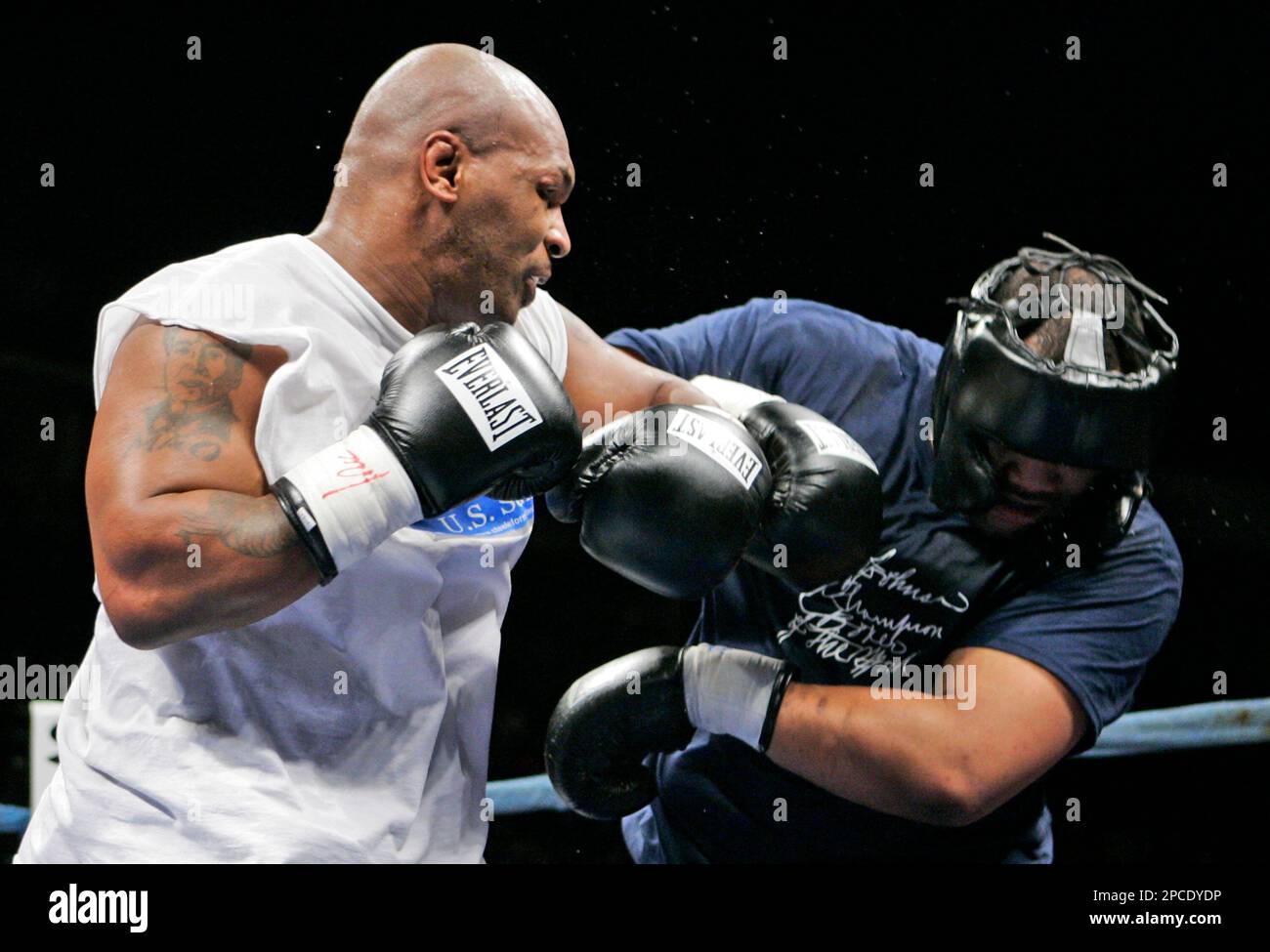 Mike Tyson, right, gives Corey "T-Rex" Sanders a right jab in the ...