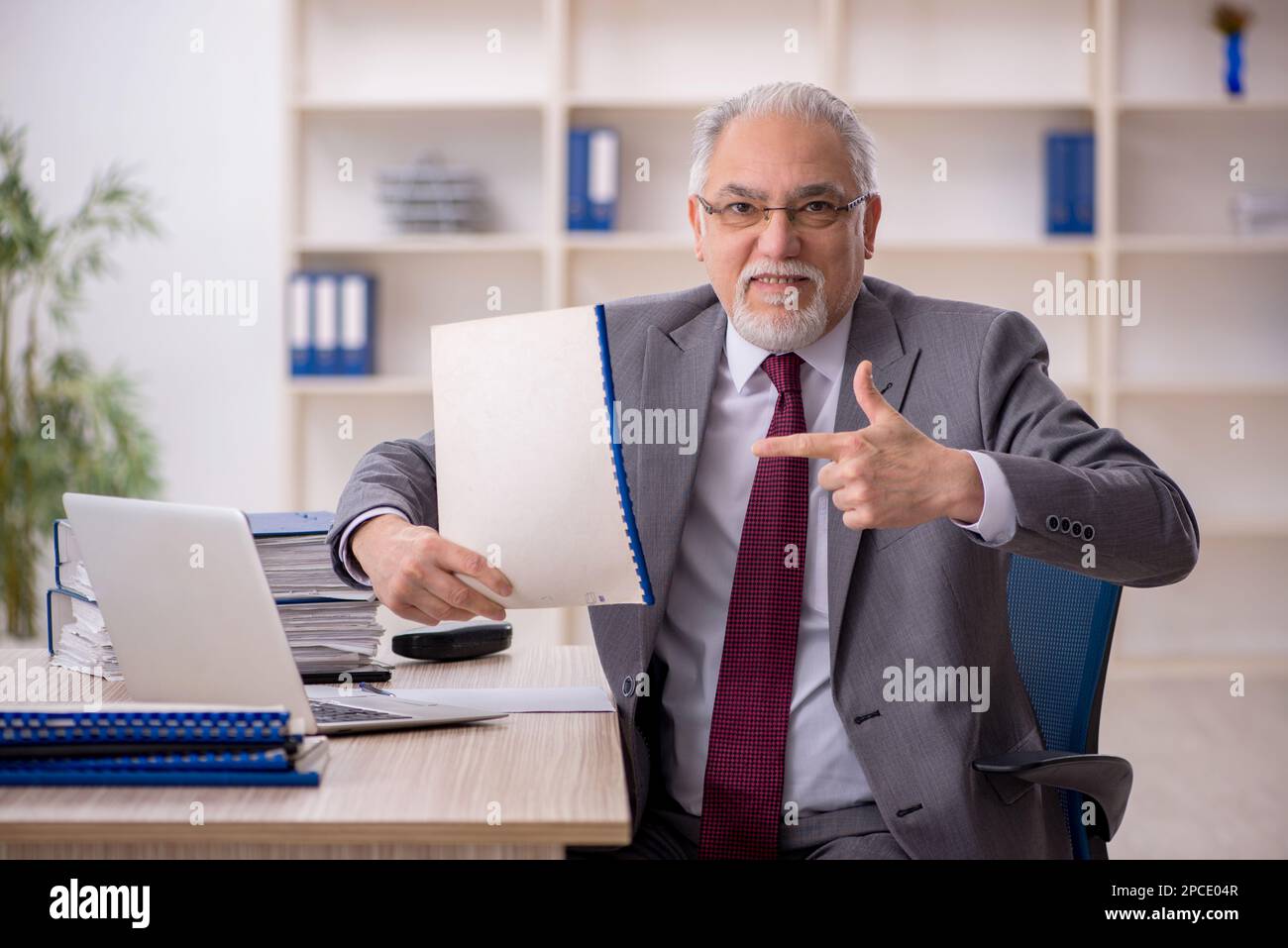 Old boss employee sitting at workplace Stock Photo - Alamy