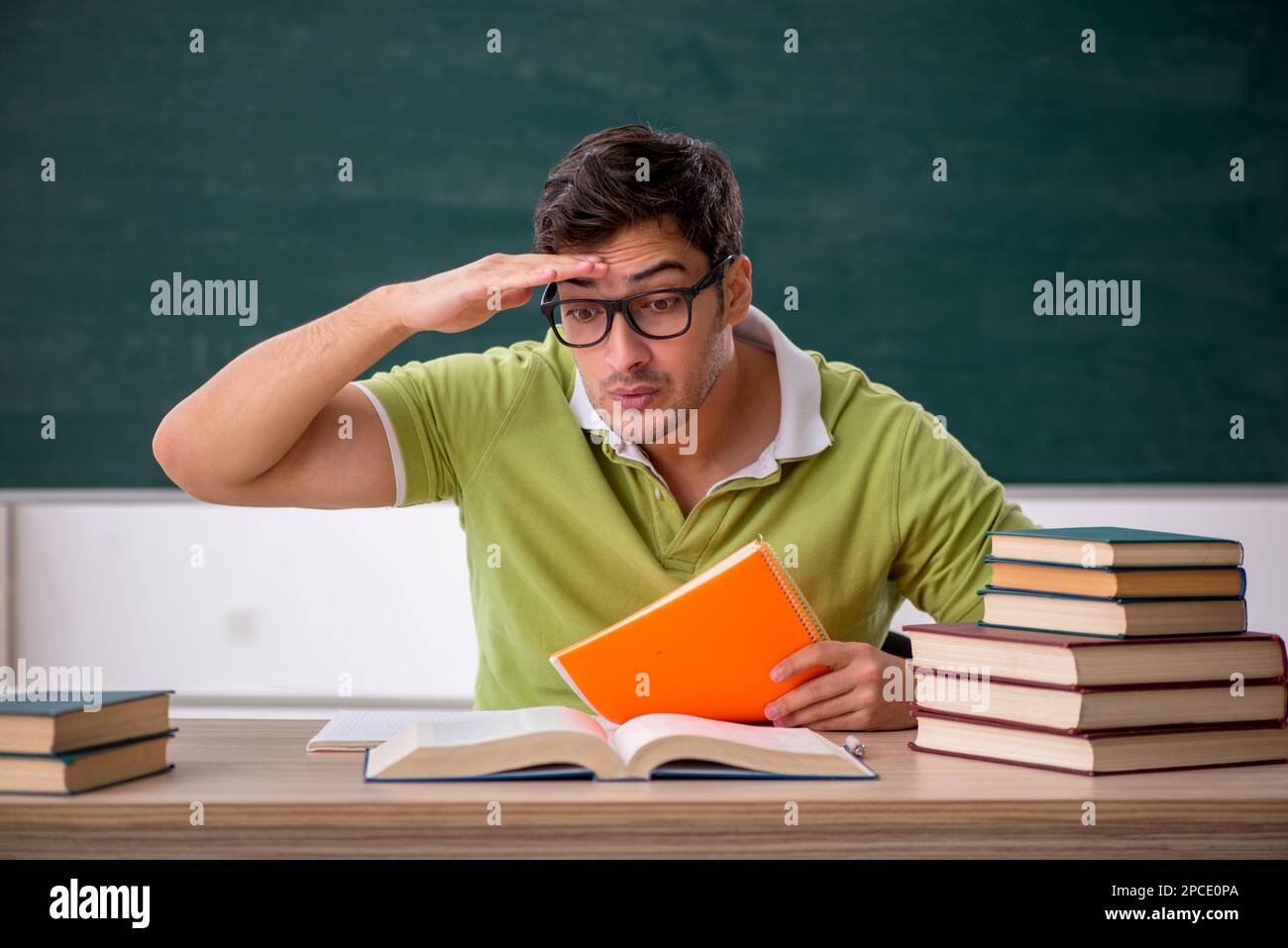 Young student sitting in the classroom in front of blackboard Stock ...