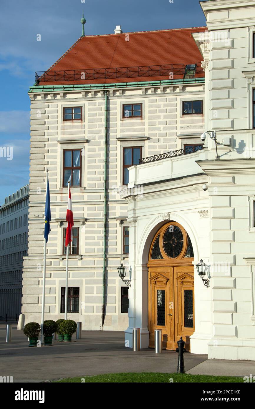 The late afternoon view of historic buildings with flags in Vienna old ...