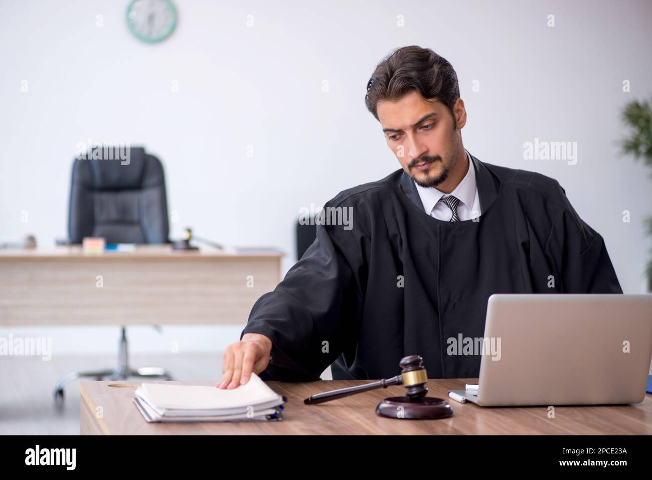 Young judge working in the courthouse Stock Photo - Alamy