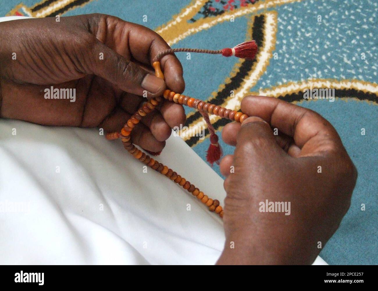 A Kenyan Muslim prays with prayer beads in Nairobi, Friday, Oct. 20 ...