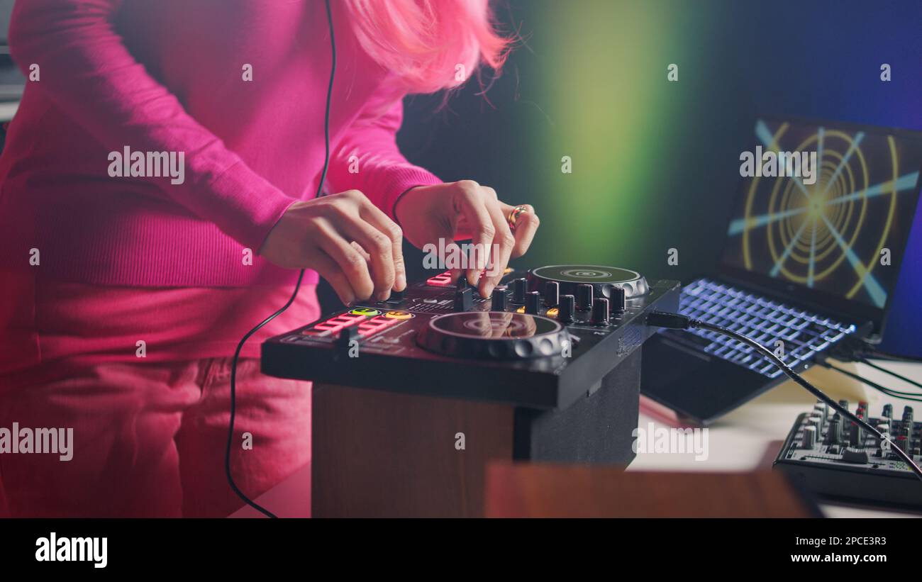 Musician standing at dj table playing electronic song at professional ...