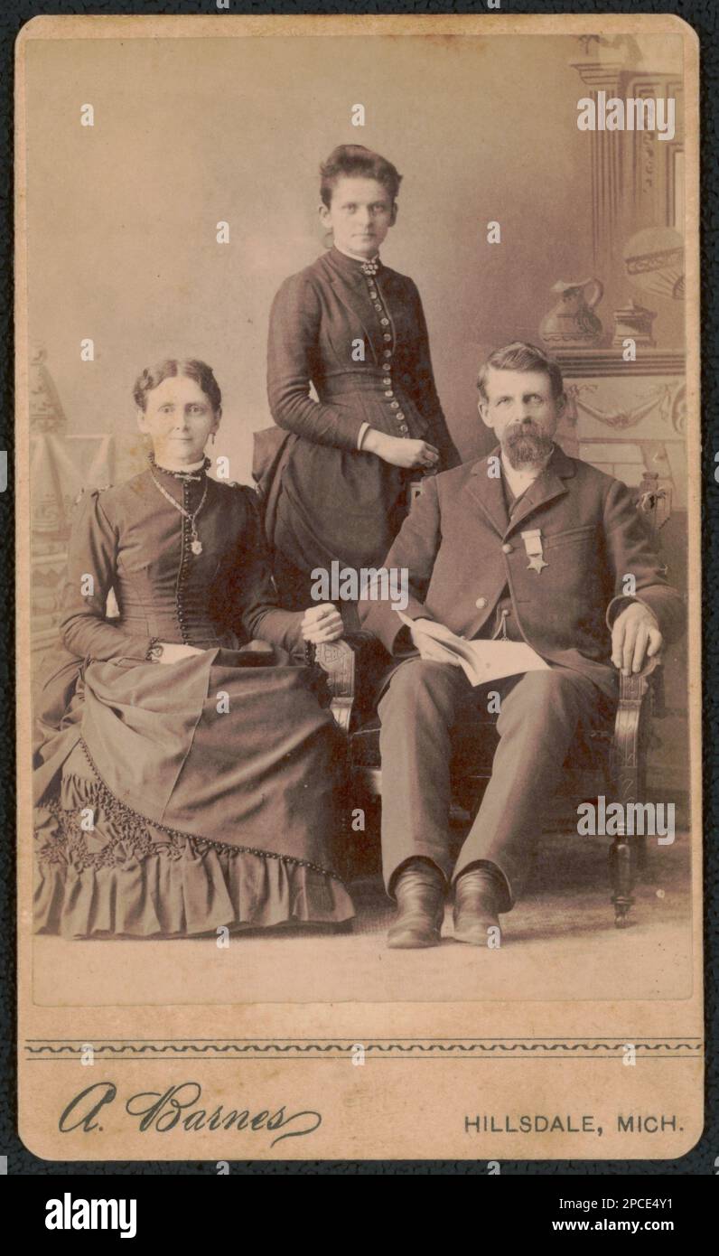 Unidentified Civil War veteran wearing Grand Army of the Republic medal with his wife and ...
