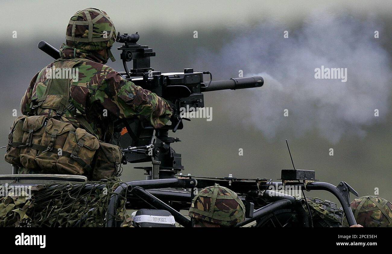 British Royal Marines fire a new grenade machine gun mounted on a Land ...