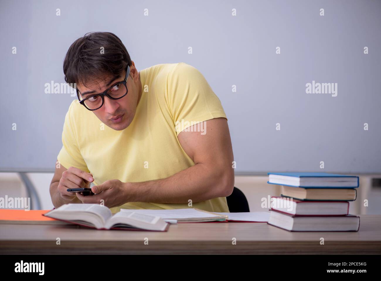 Young student sitting in the classroom Stock Photo - Alamy