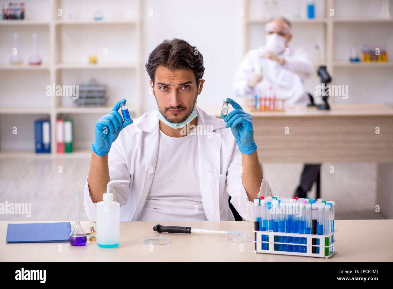 Two chemist working at the lab Stock Photo - Alamy