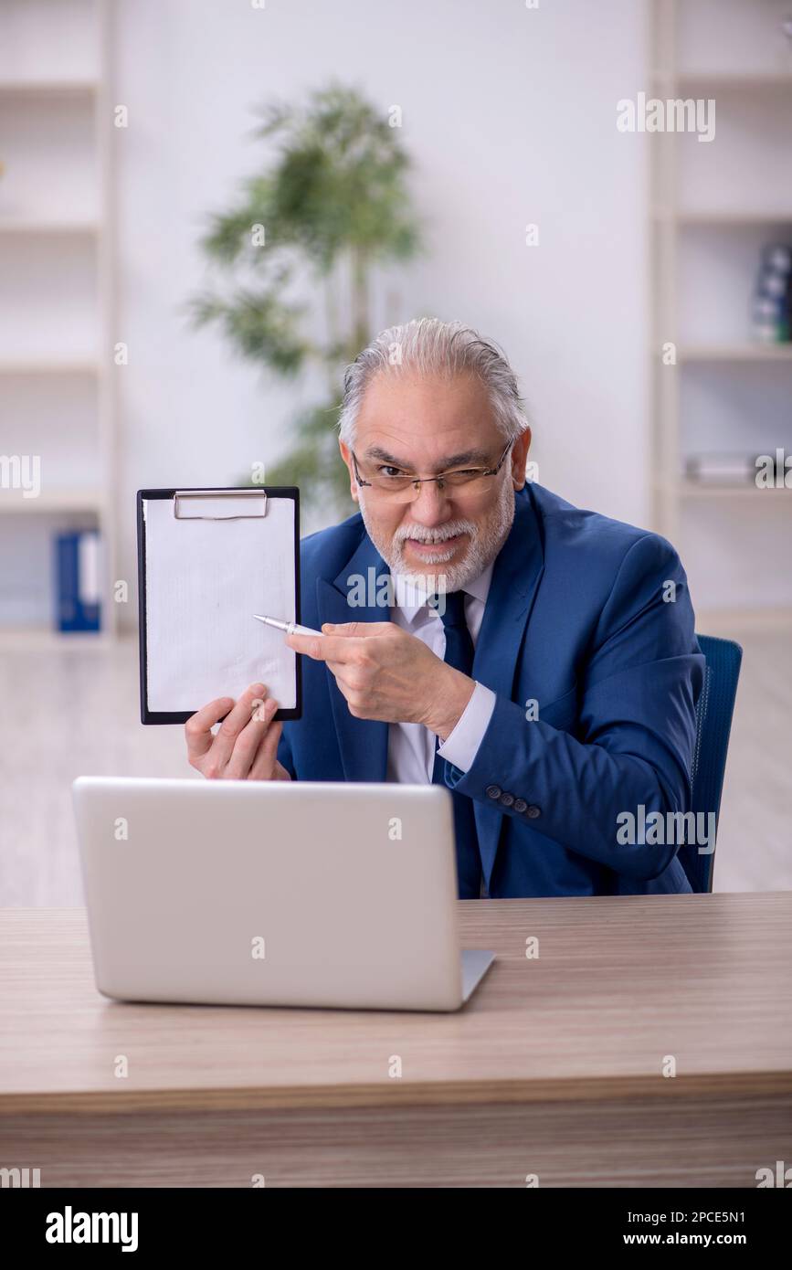 Old boss working in the office Stock Photo - Alamy