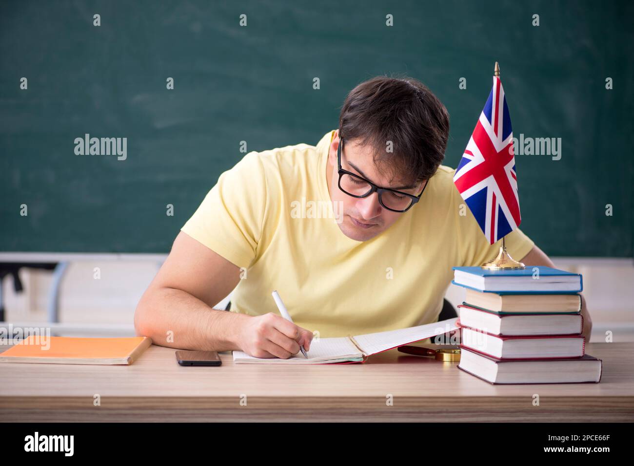 Young English language teacher sitting in the classroom Stock Photo - Alamy