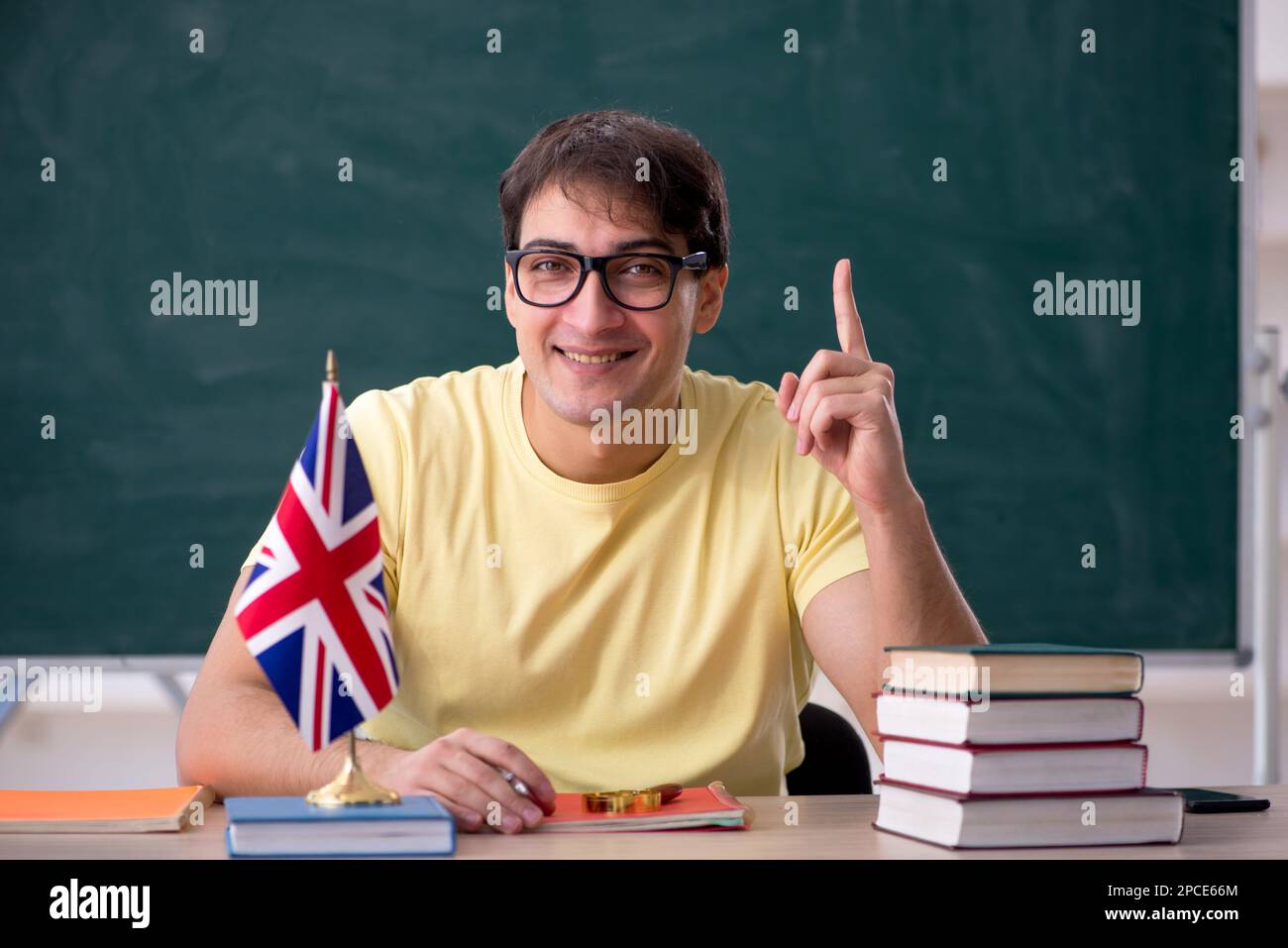 Young English language teacher sitting in the classroom Stock Photo - Alamy