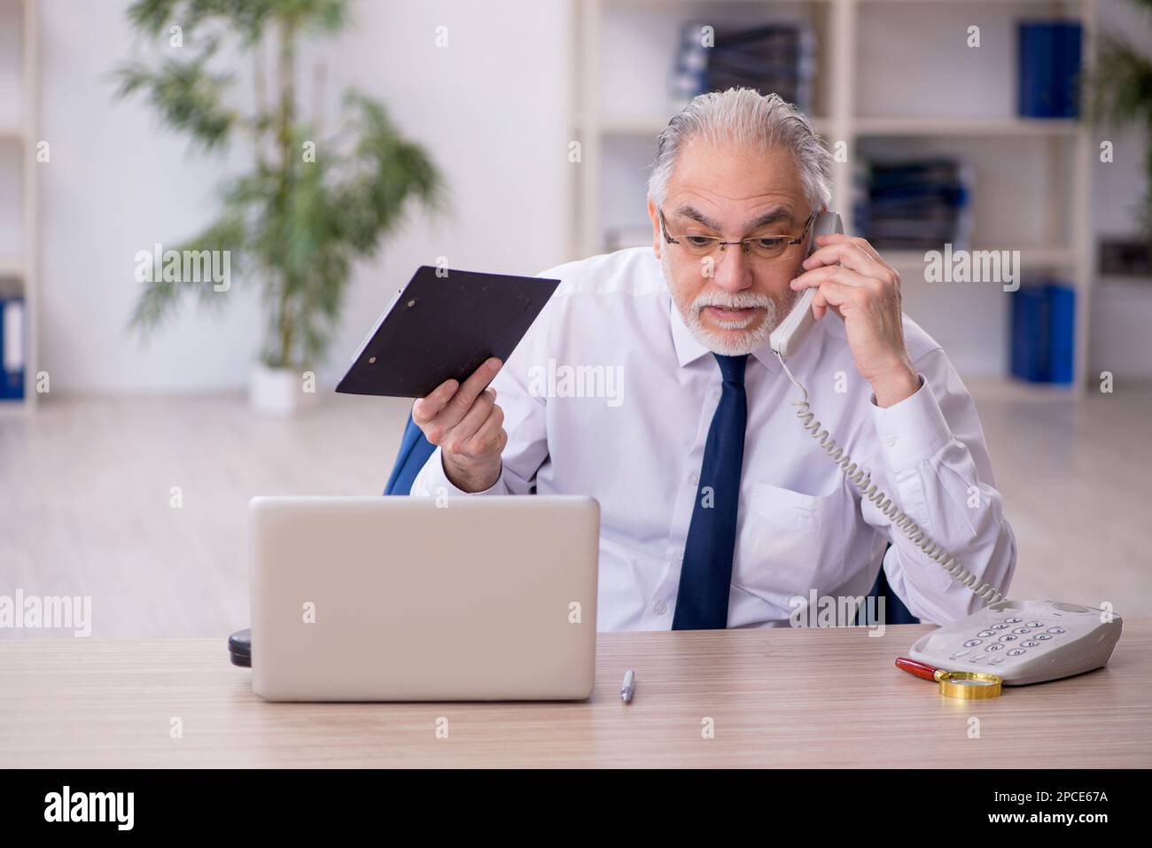 Old boss working in the office Stock Photo - Alamy