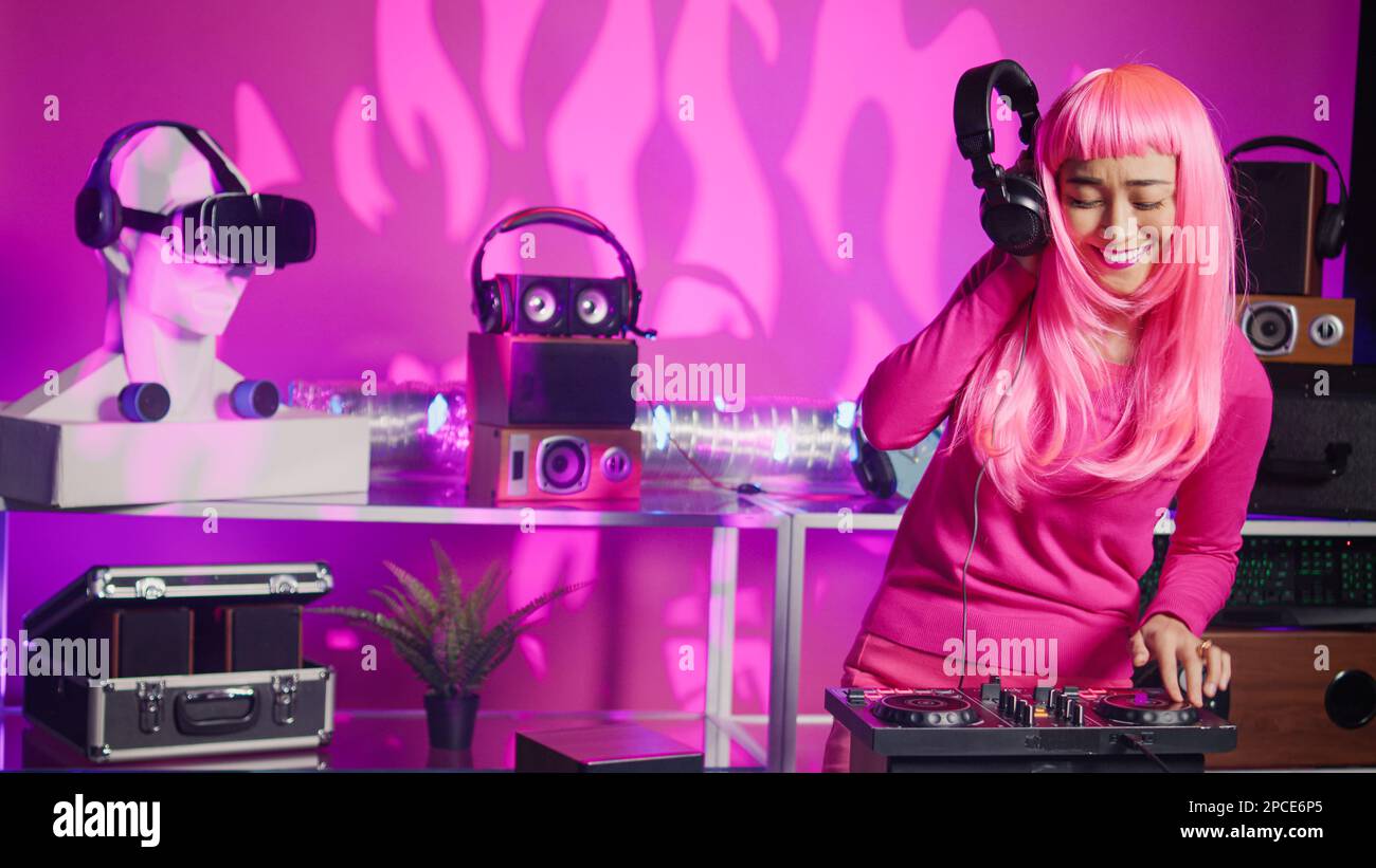 Artist playing electronic song using professional turntables, enjoying ...