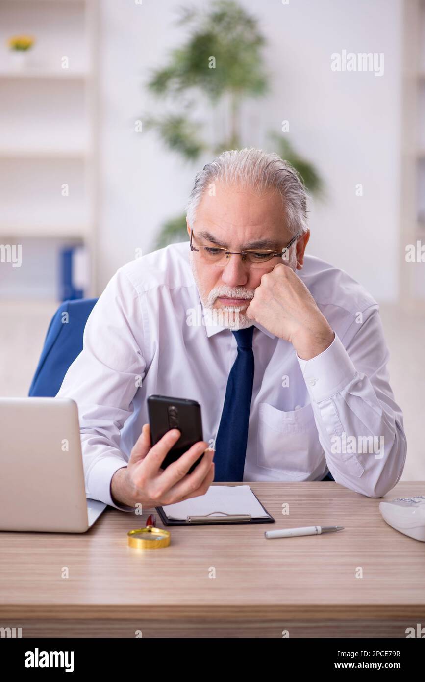 Old boss working in the office Stock Photo - Alamy