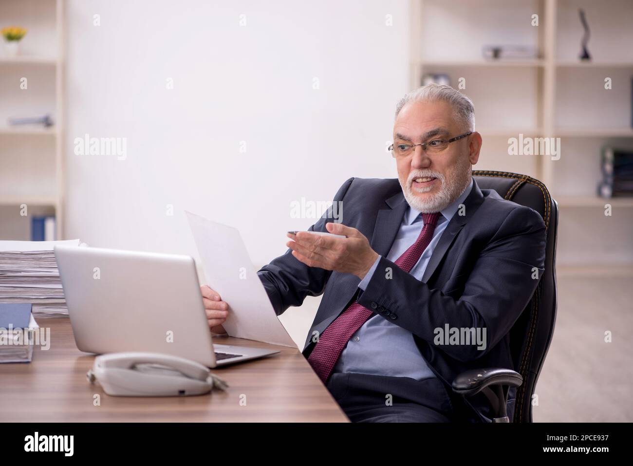 Old boss working in the office Stock Photo - Alamy