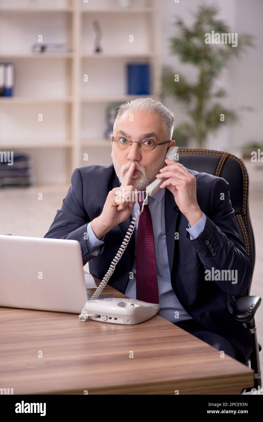 Old boss working in the office Stock Photo - Alamy