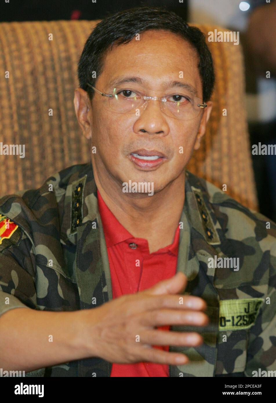 Defiant Makati Mayor Jejomar Binay, wearing a Philippine Marines ...