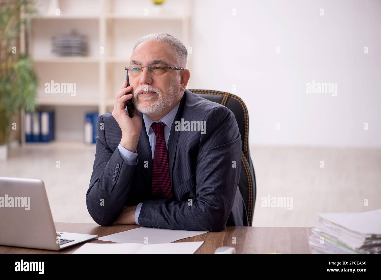 Old boss working in the office Stock Photo - Alamy