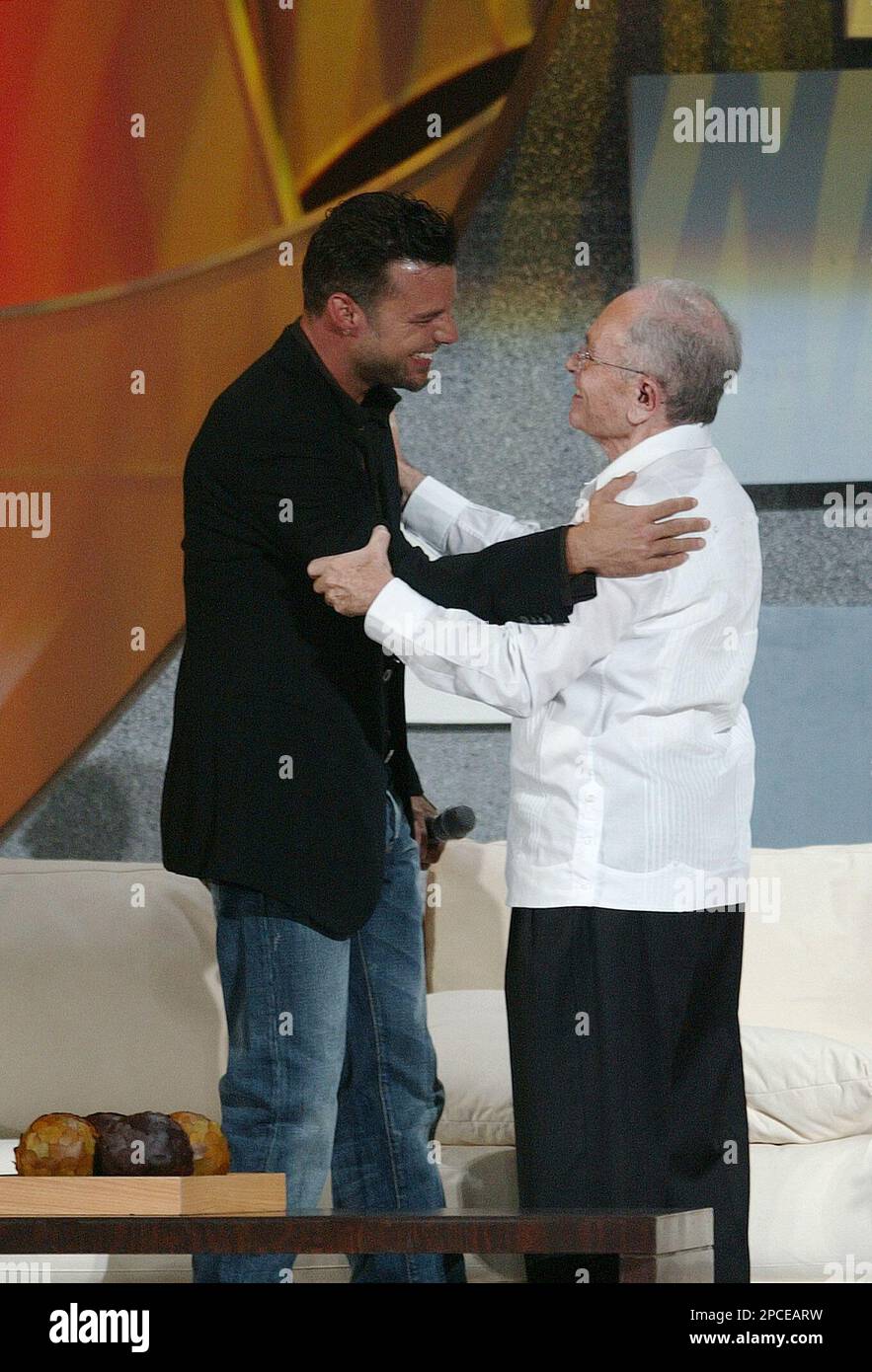 Puerto Rican singer Ricky Martin, left, embraces Mexican TV host Raul ...