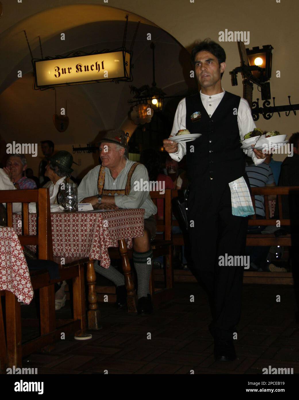A waiter delivers food at Hofbrauhaus, a famous beer hall. (AP Photo ...