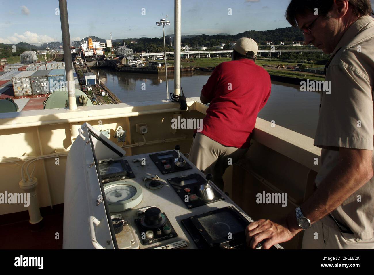 A Panama Canal pilot, in red T-shirt, watches an approximation maneuver ...