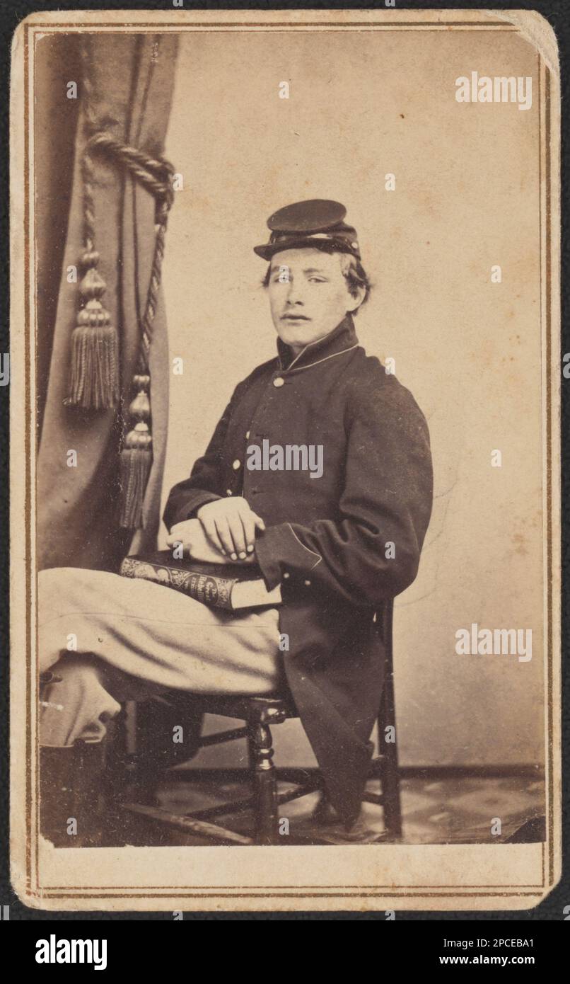 Unidentified soldier in Union uniform holding book "The Great Rebellion ...