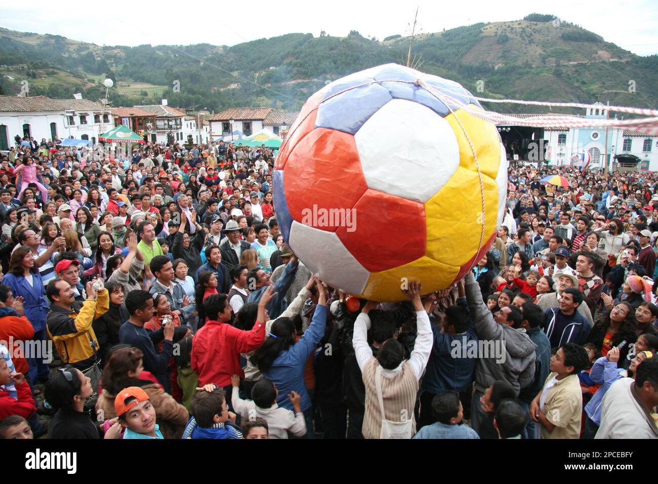 People hold aloft a giant hand-stitched soccer ball Mongui square, 170 ...