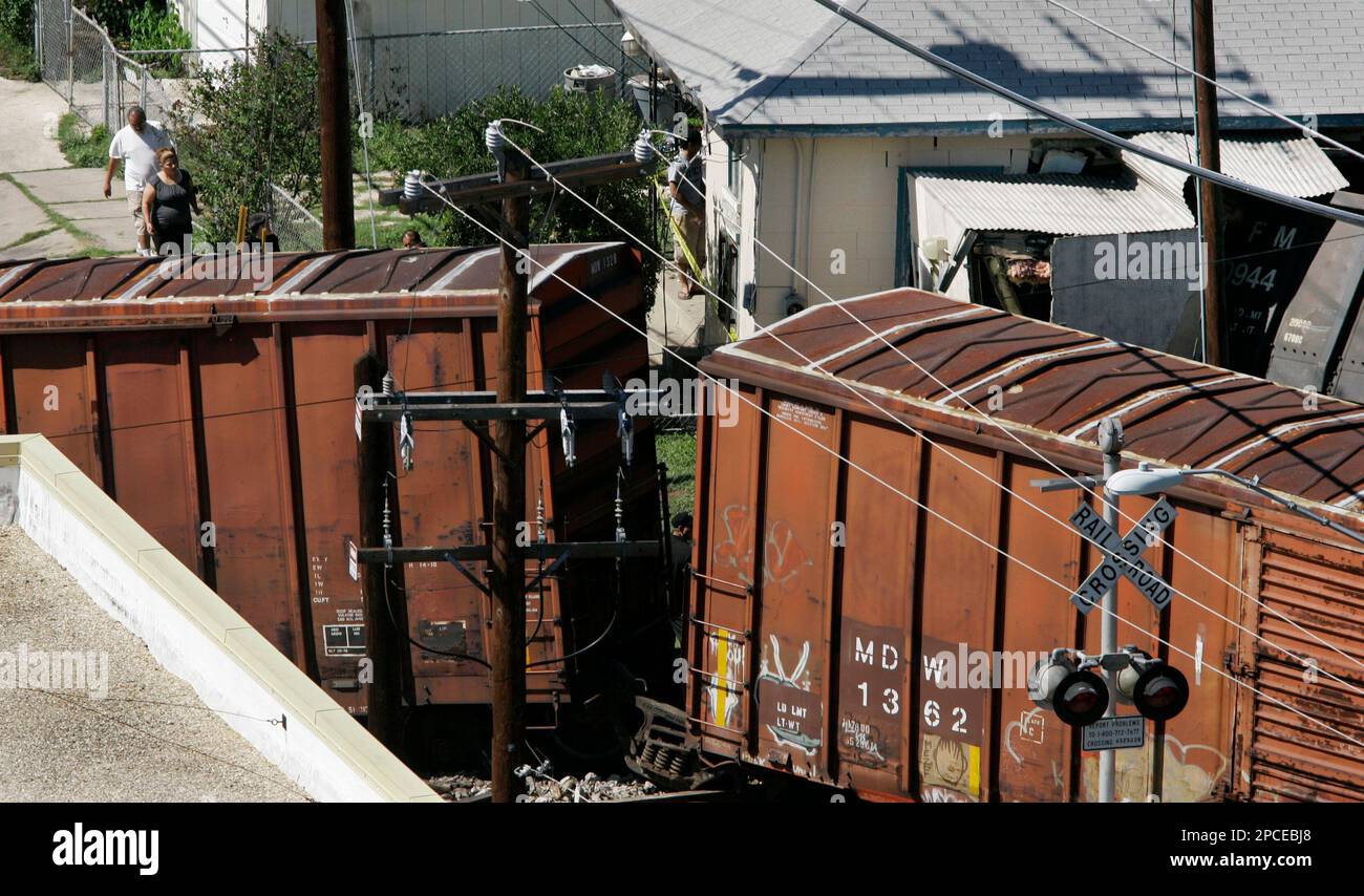 Some of 18 derailed train cars are seen in a residential neighborhood ...