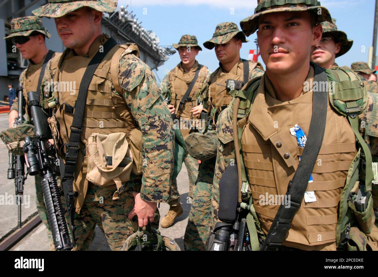 U.S. Marines disembark from the amphibious assault ship USS Essex upon ...