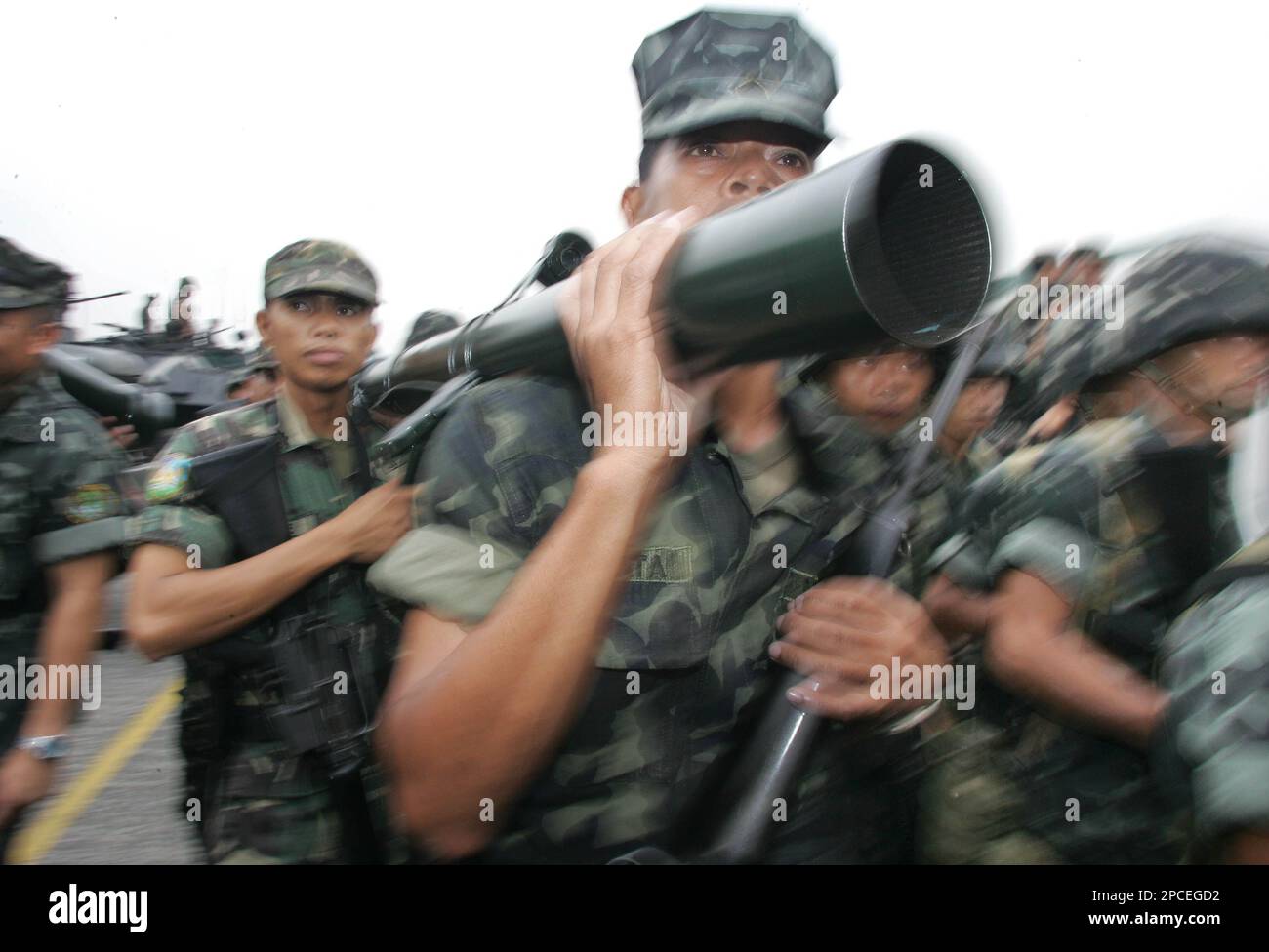 Filipino troopers carry a high-powered weapon during an inspection of ...