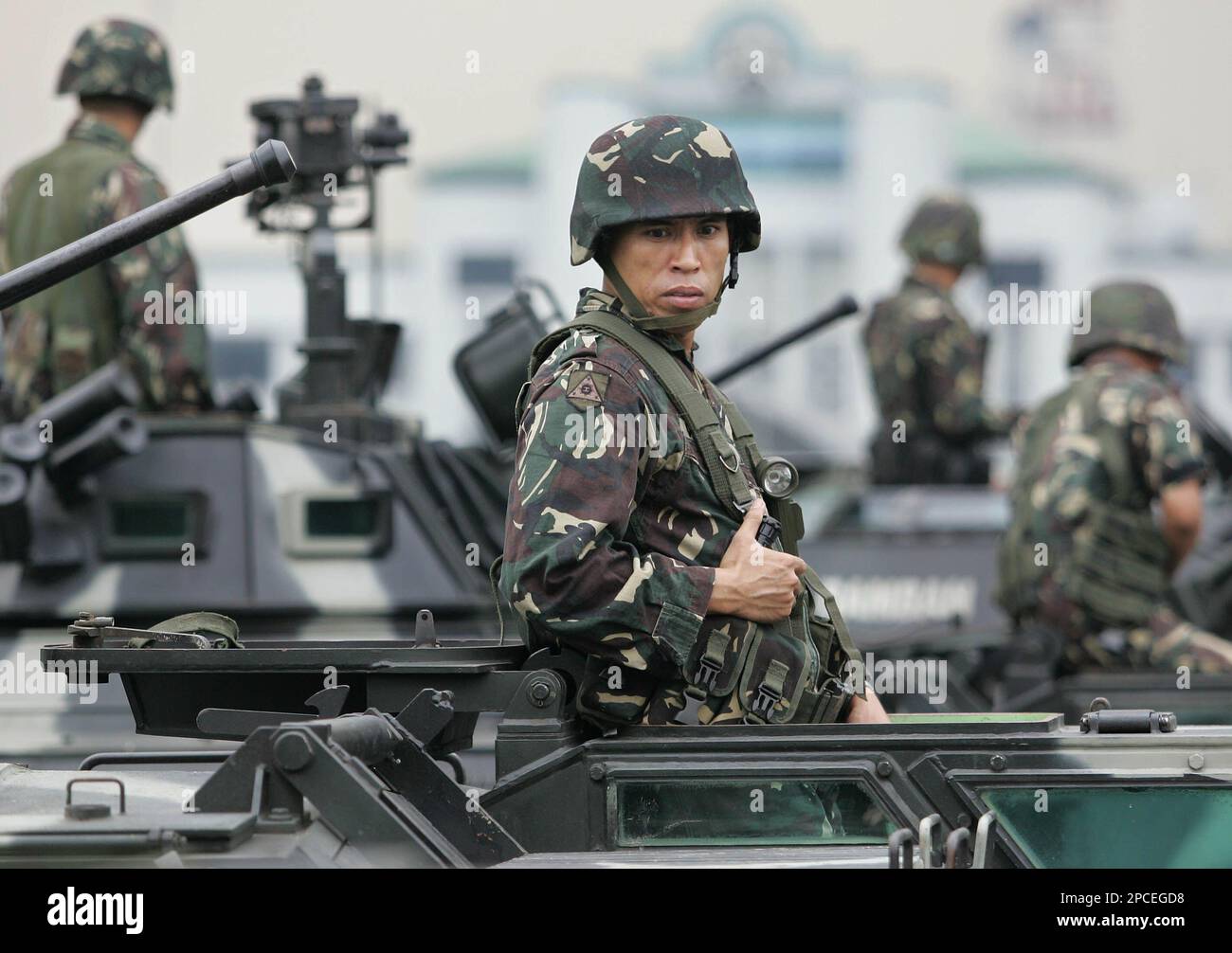 A Filipino trooper waits on top of an Armored Personnel Carrier during ...