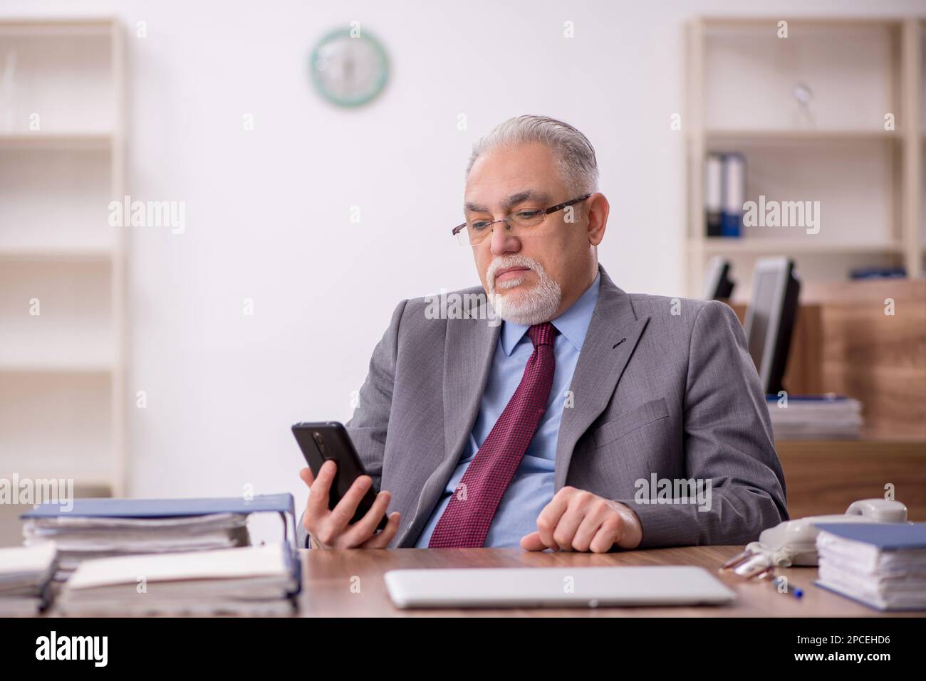 Old boss employee working at workplace Stock Photo - Alamy