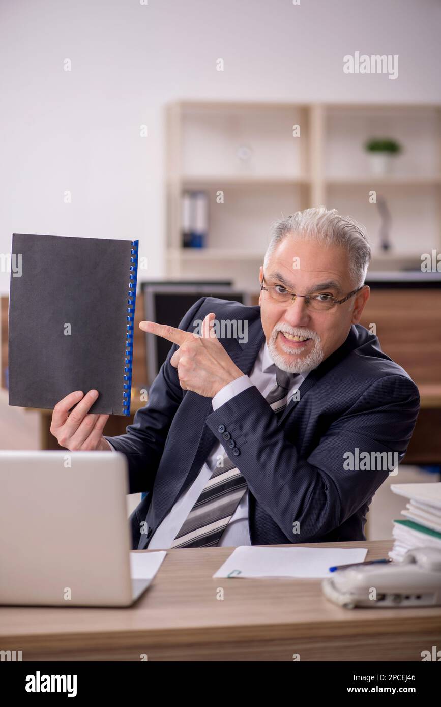 Old boss employee working at workplace Stock Photo - Alamy
