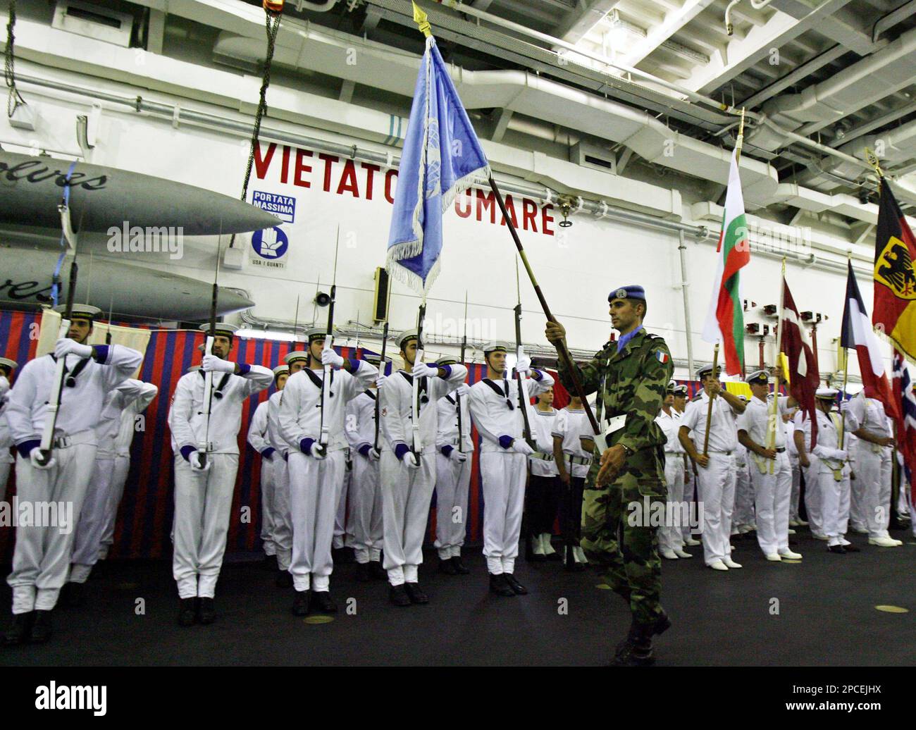 A French U.N. peacekeeper holds a U.N. flag as he marches in front of ...