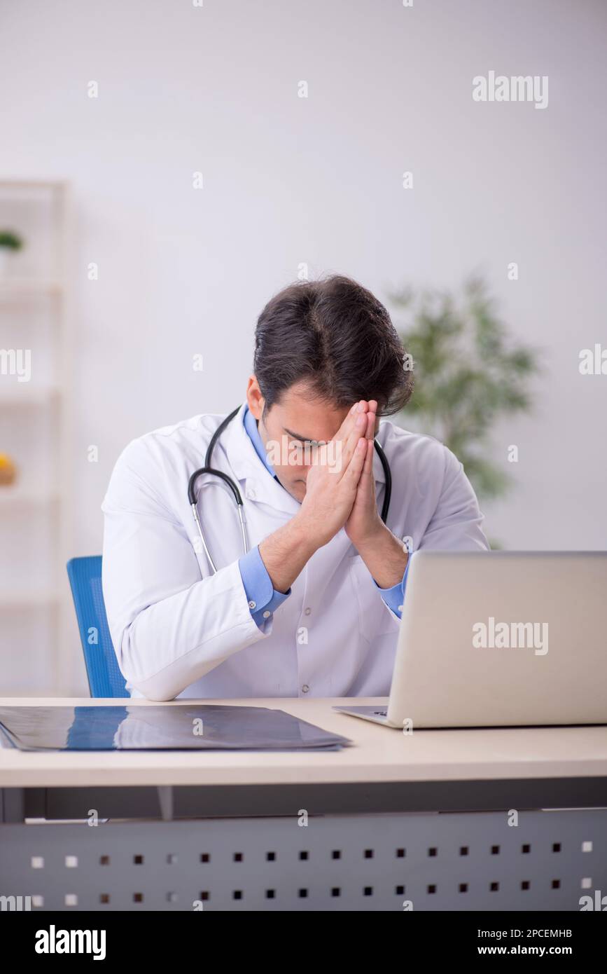 Young doctor being tired after night shift Stock Photo - Alamy