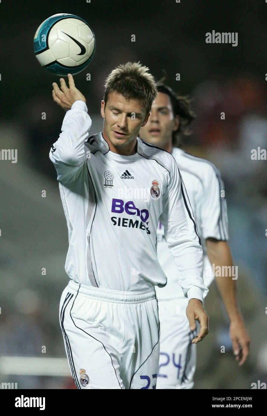 Real Madrid player David Beckham, front, passes the ball to teammate ...