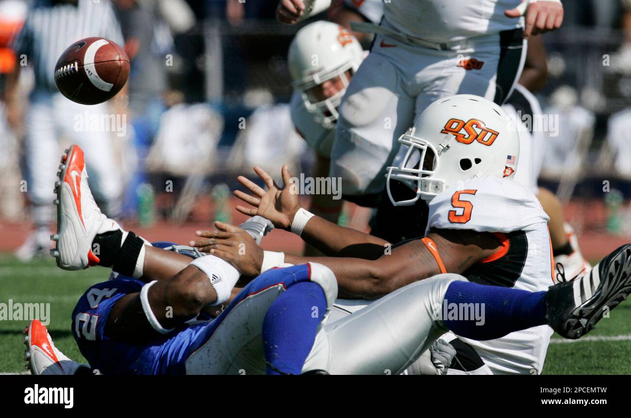 Oklahoma State running back Keith Toston (5) loses the ball as he is ...