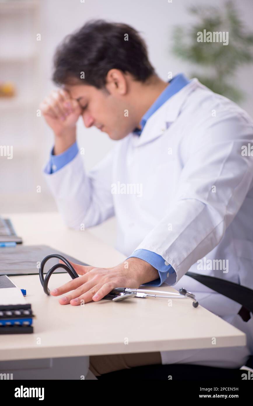 Young doctor being tired after night shift Stock Photo - Alamy